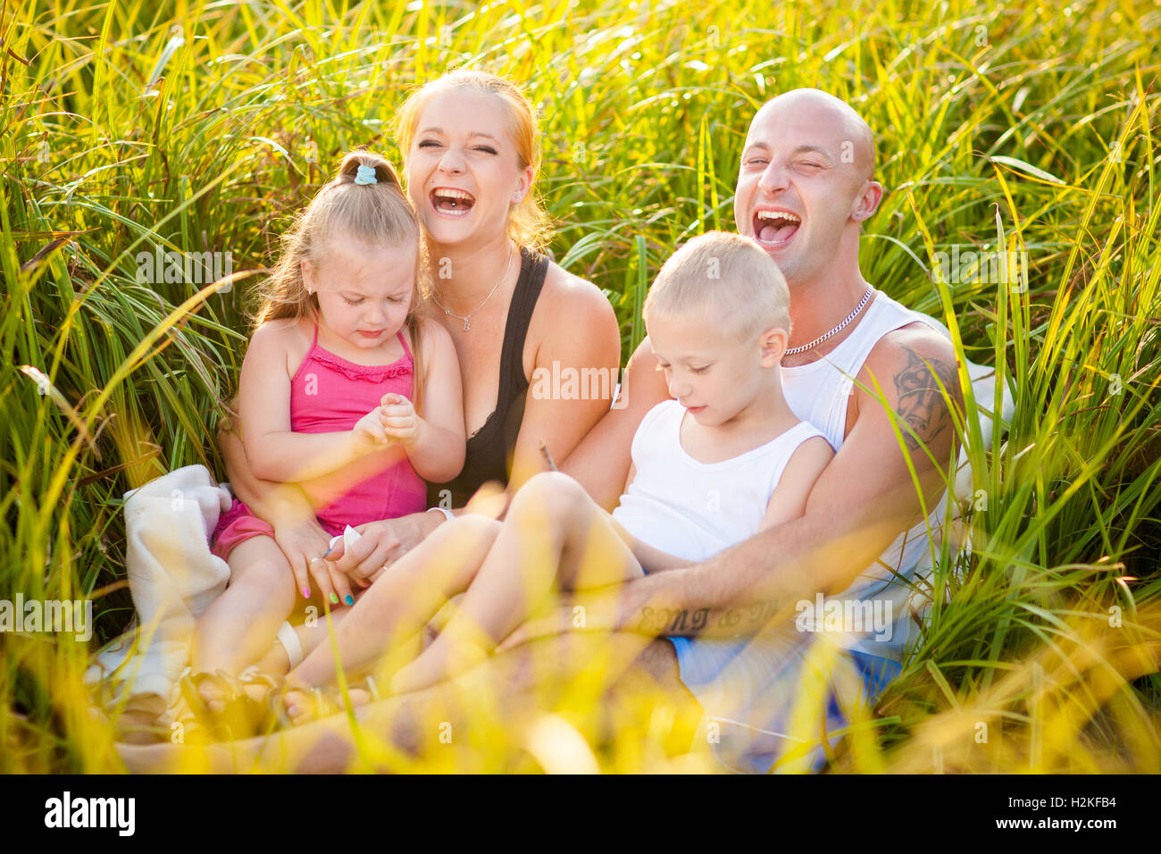 Family having fun in a park during beautiful summer evening Stock Photo ...