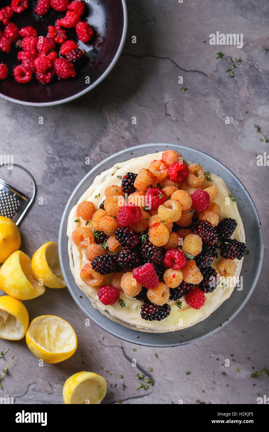 Sponge cake with lemon cream, decorated by fresh colorful yellow red ...