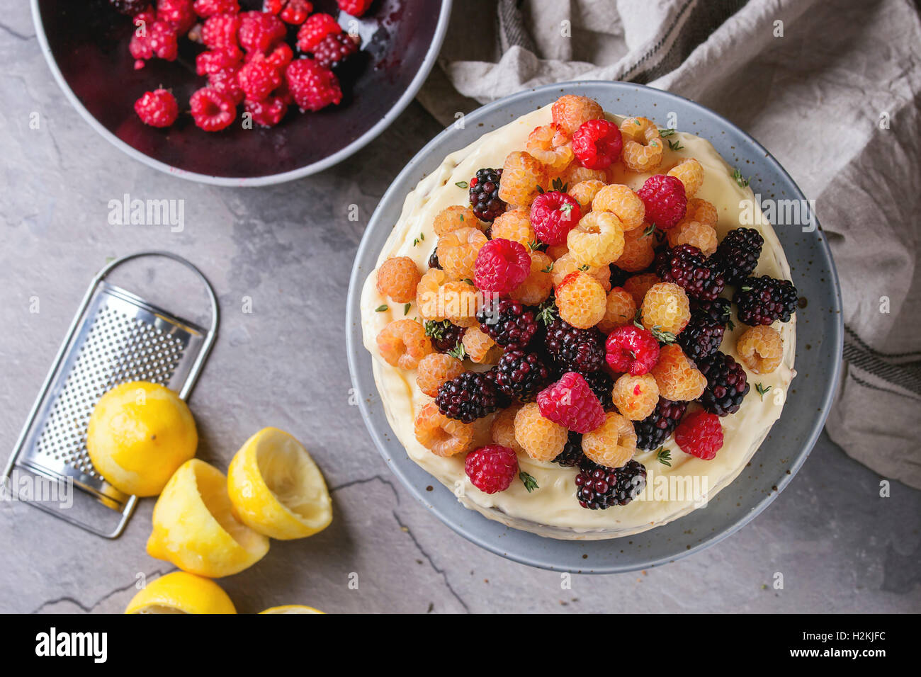 Sponge cake with lemon cream, decorated by fresh colorful yellow red ...