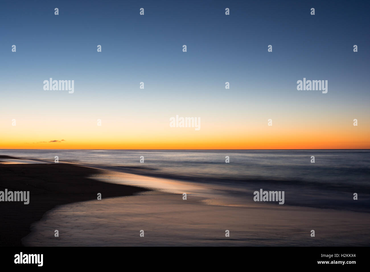 The sun rises across the Atlantic Ocean from east Long Island, New York ...