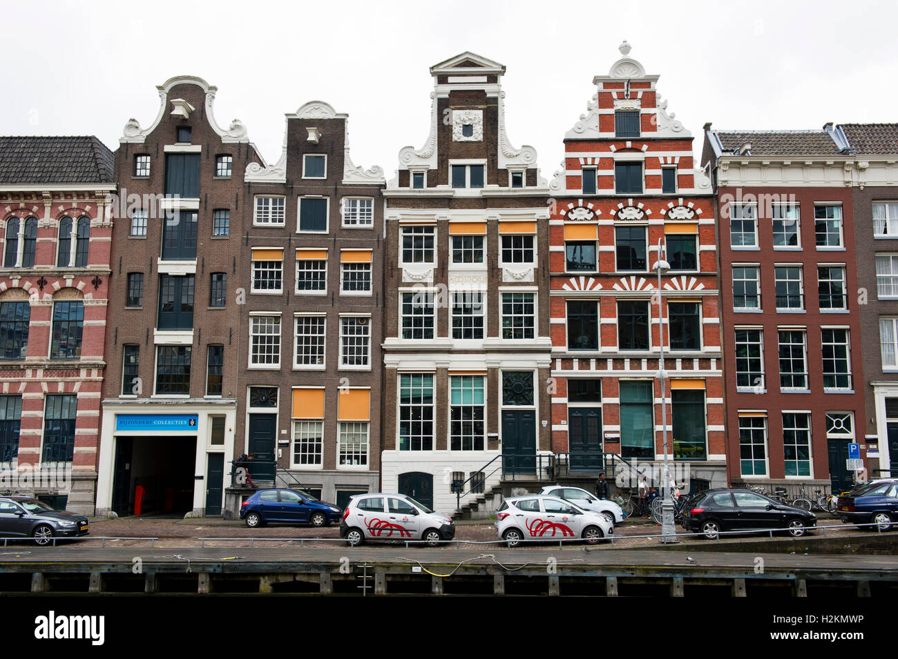 Traditional dutch narrow buildings by the canal in Amsterdam, Holland ...