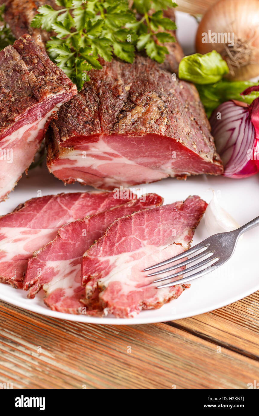 Dry-cured ham slices on white plate Stock Photo - Alamy