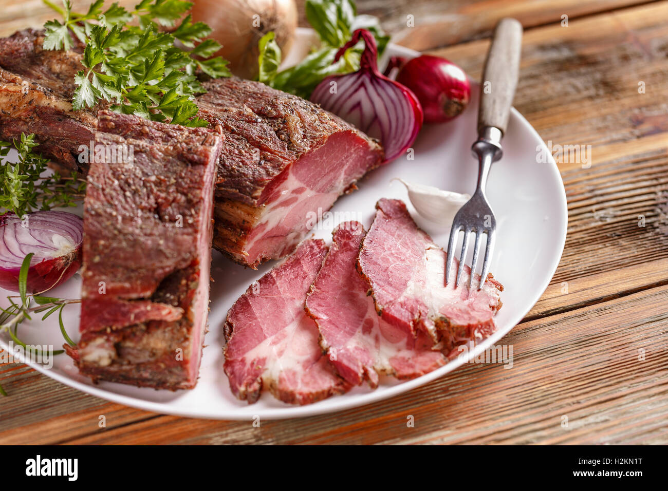 Slices and whole dry pork neck Stock Photo - Alamy