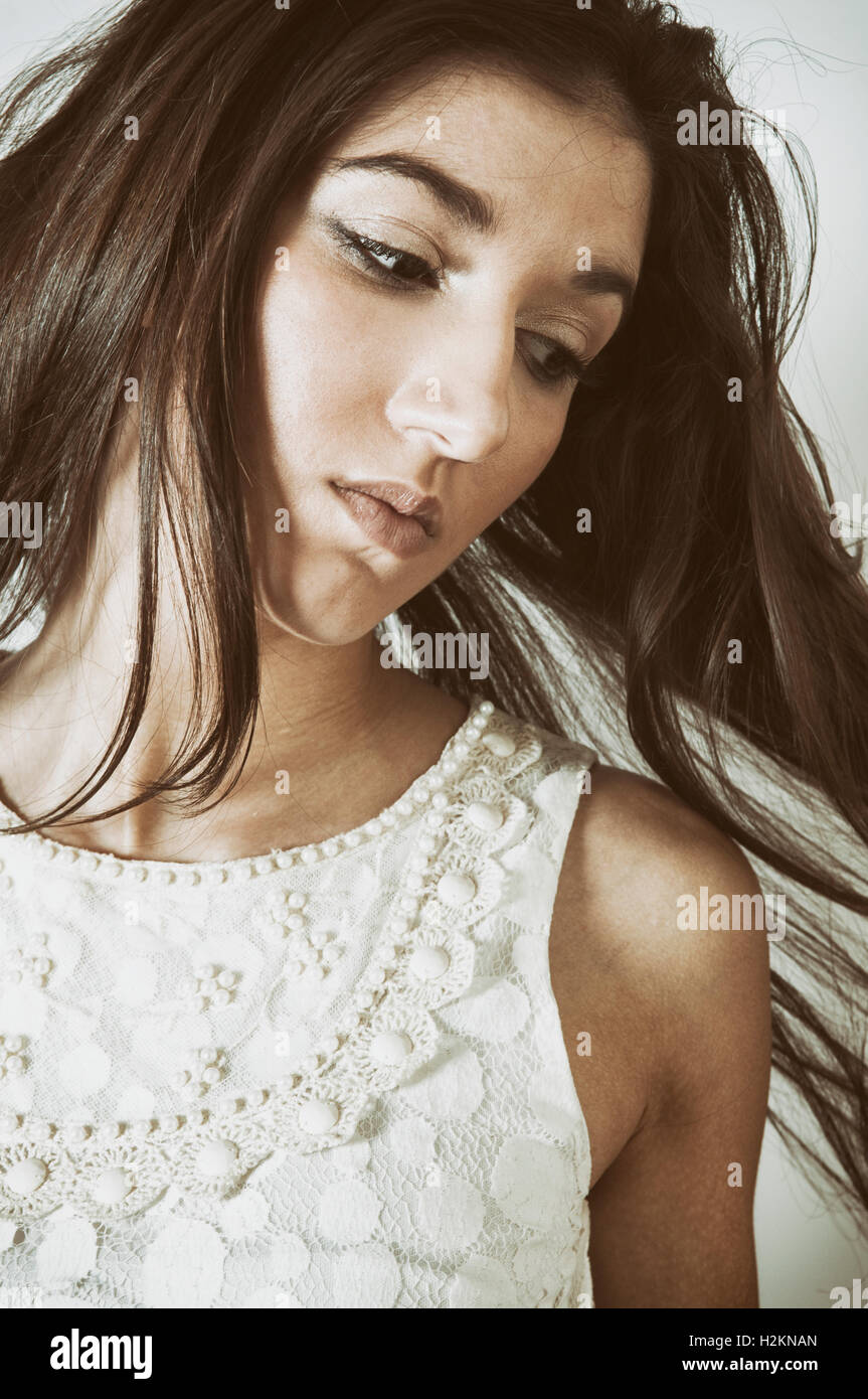 Serious young woman looking behind Stock Photo - Alamy
