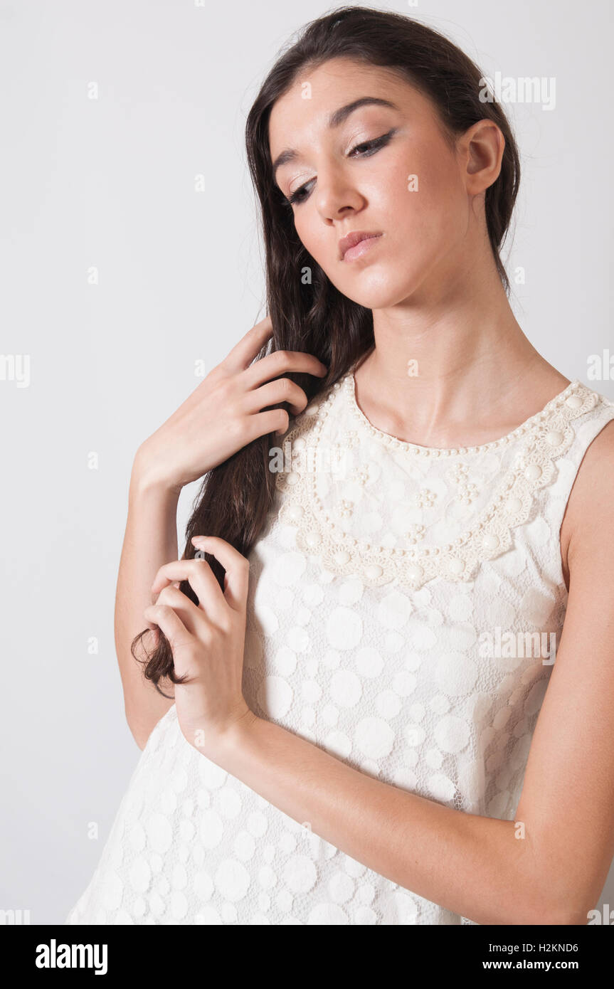 Beautiful young woman hand touching hair Stock Photo - Alamy