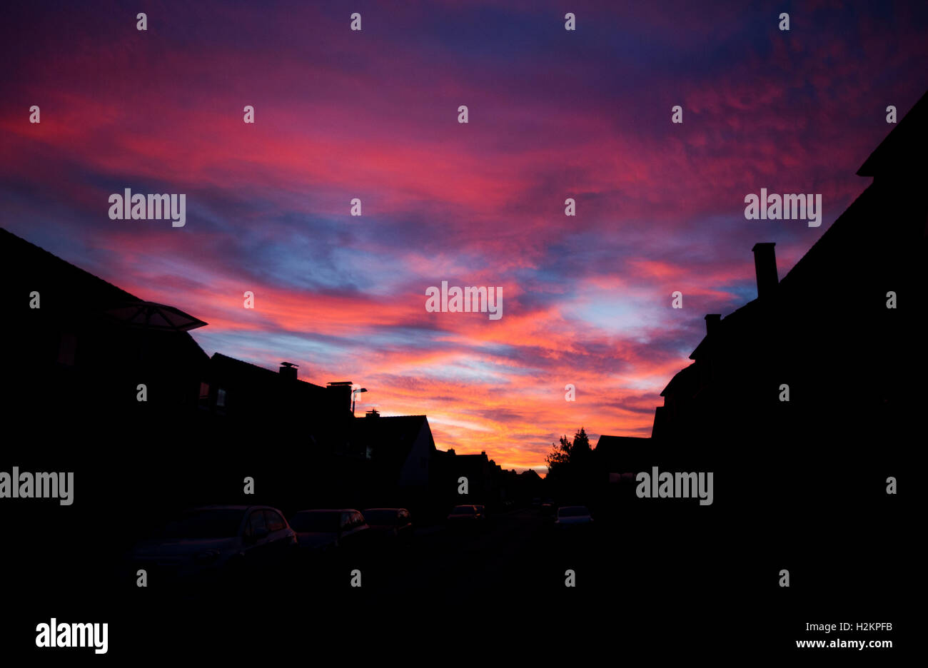 Clouds coloured by the sunset above houses in Herten, Germany, 28 ...