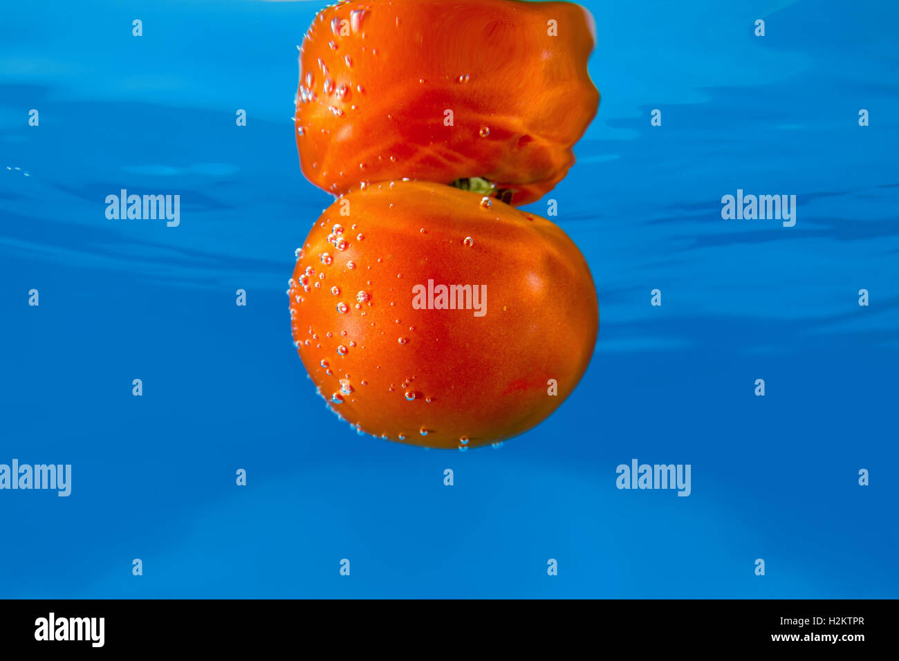 Odessa, Ukraine. 18th Sep, 2016. Tomato splashing in blue water ...