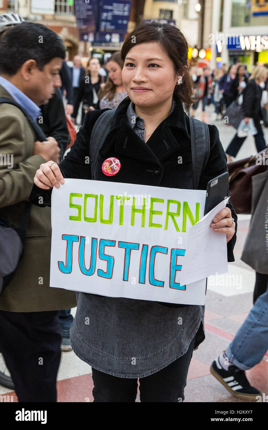 London, UK. 29th September, 2016. A Southern Rail passenger holds a ...