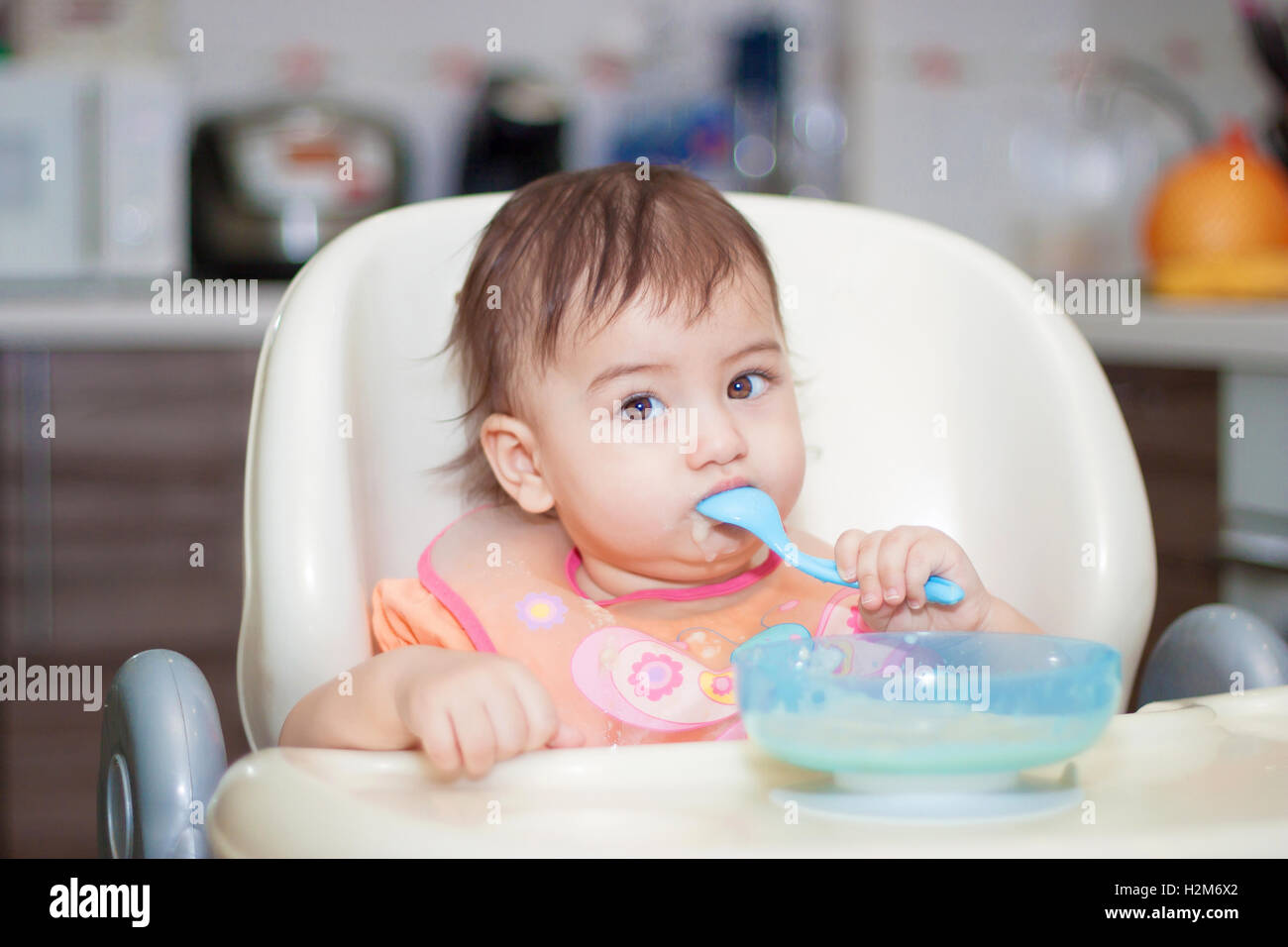 baby eating in the kitchen Stock Photo - Alamy