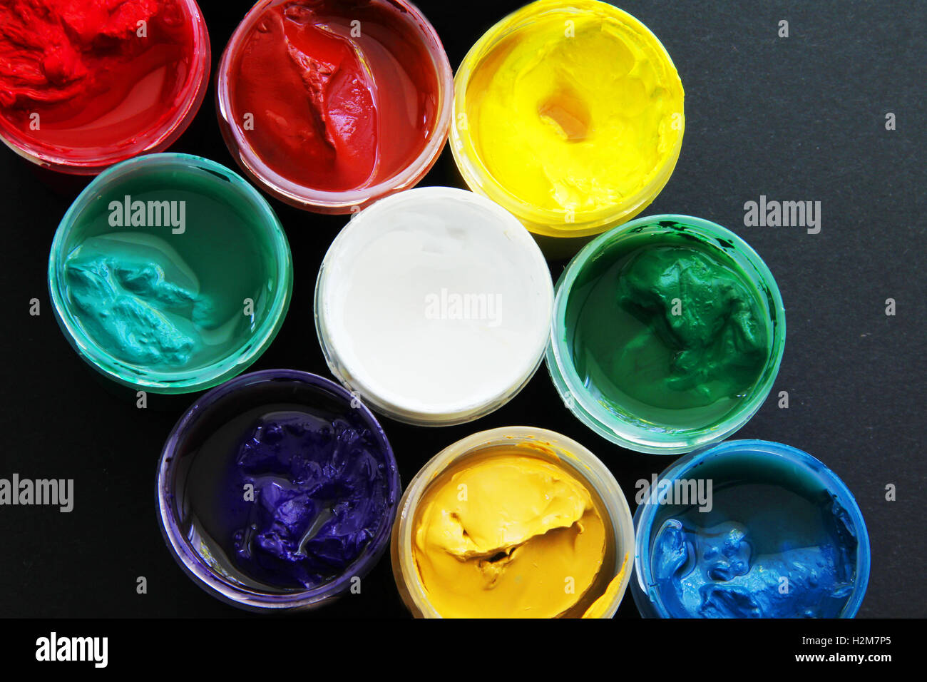 Gouache of different colors beautiful background on black Stock Photo ...