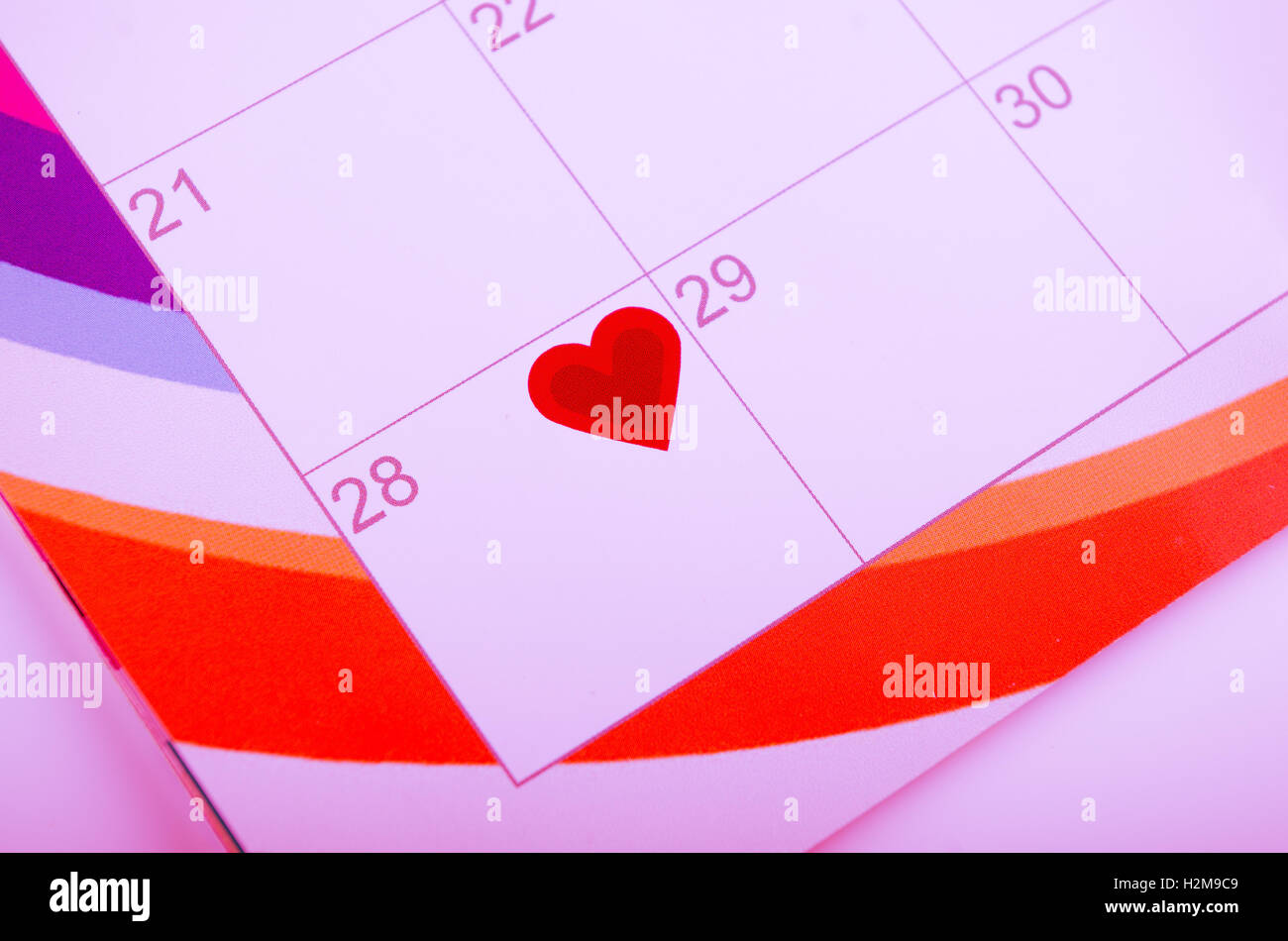 Calender page with a heart Stock Photo - Alamy