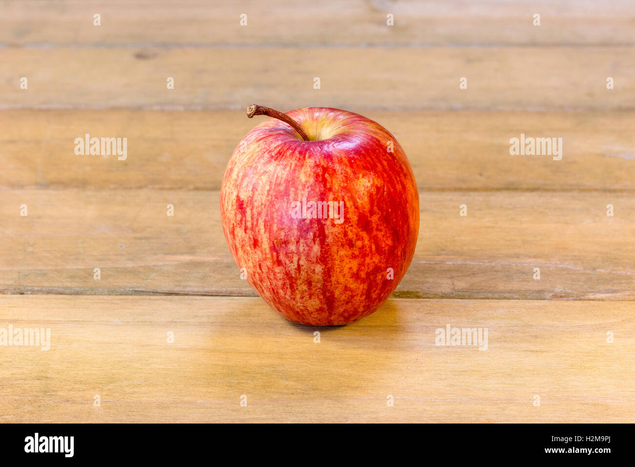 Apple isolated on table Stock Photo - Alamy