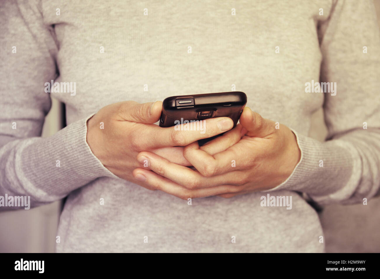 Hands holding smartphone toned in vintage style Stock Photo - Alamy