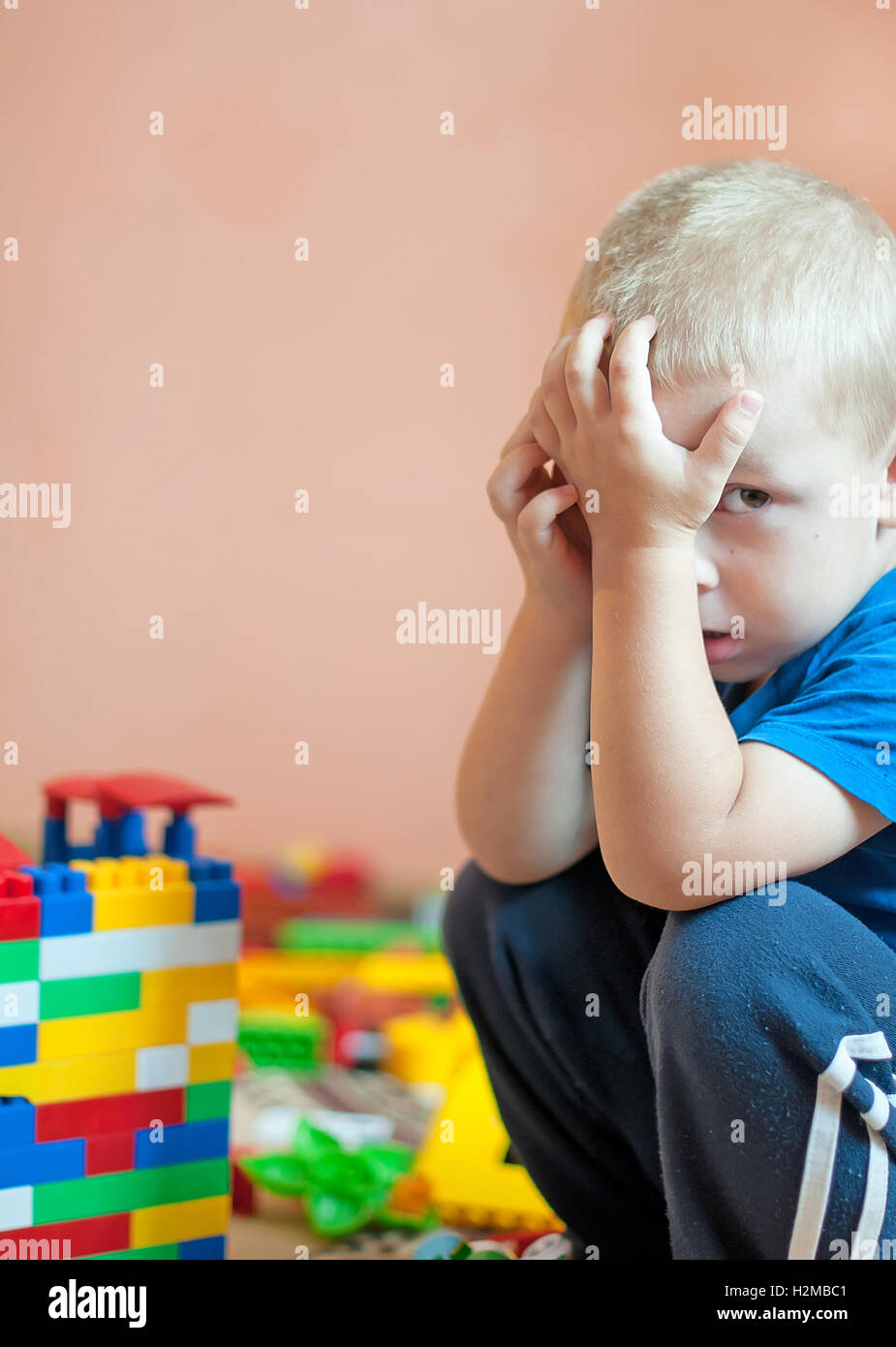 young boy, sitting on the floor, crying, looking away Stock Photo - Alamy