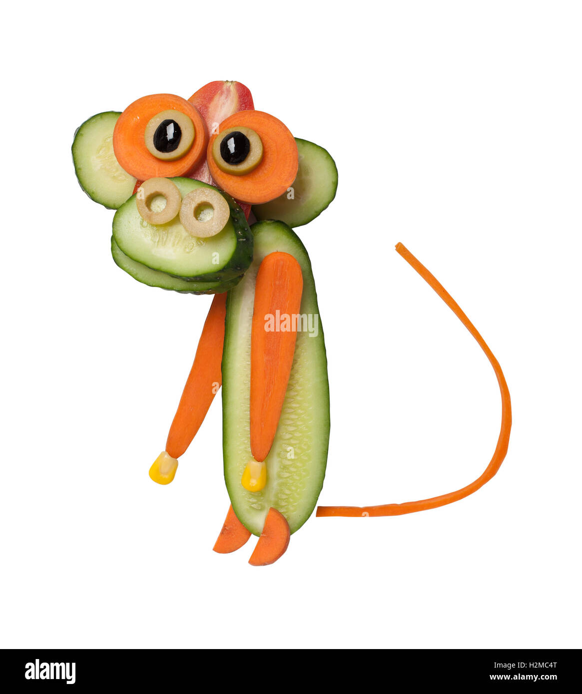 Funny monkey made of cucumber and carrot on white background Stock ...
