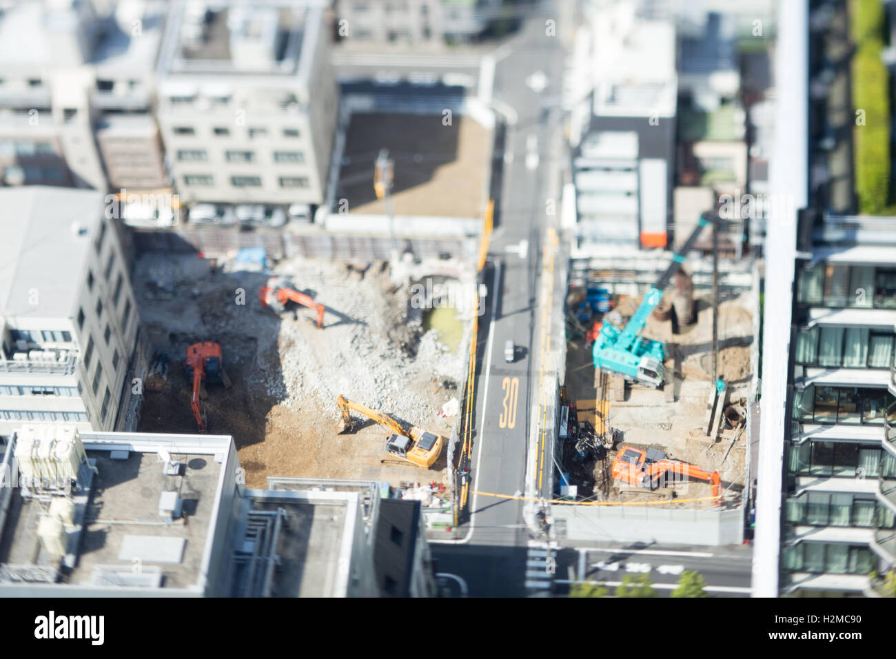 Tilt-shift bird's eye view of building construction work, Tokyo, Japan ...