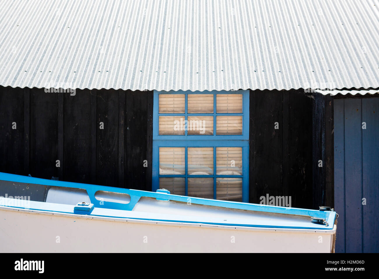 Small fishing boat outside an old shack on the beach Stock Photo - Alamy