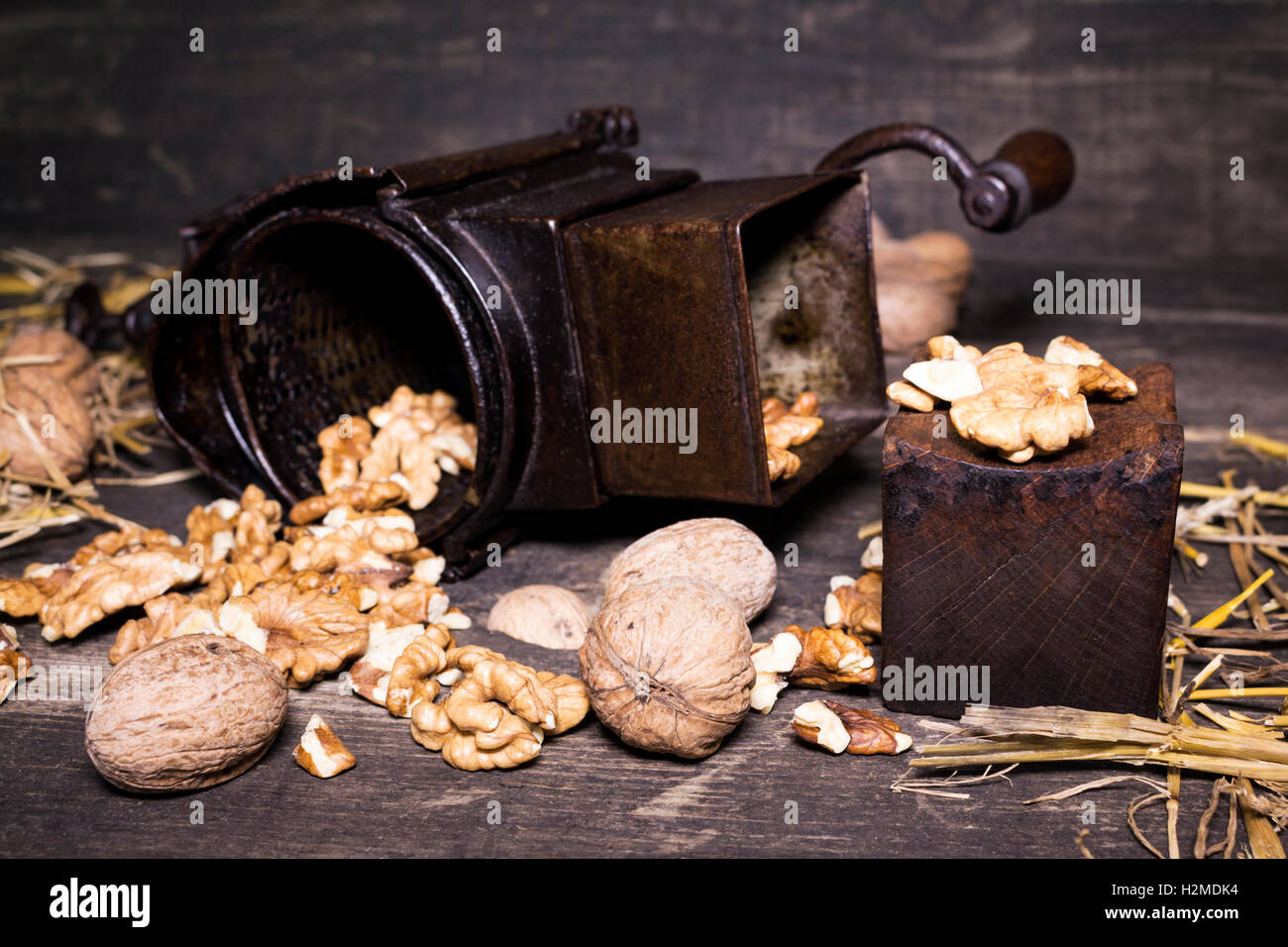 Wallnuts and hand walnuts grinder on a wooden surface Stock Photo - Alamy