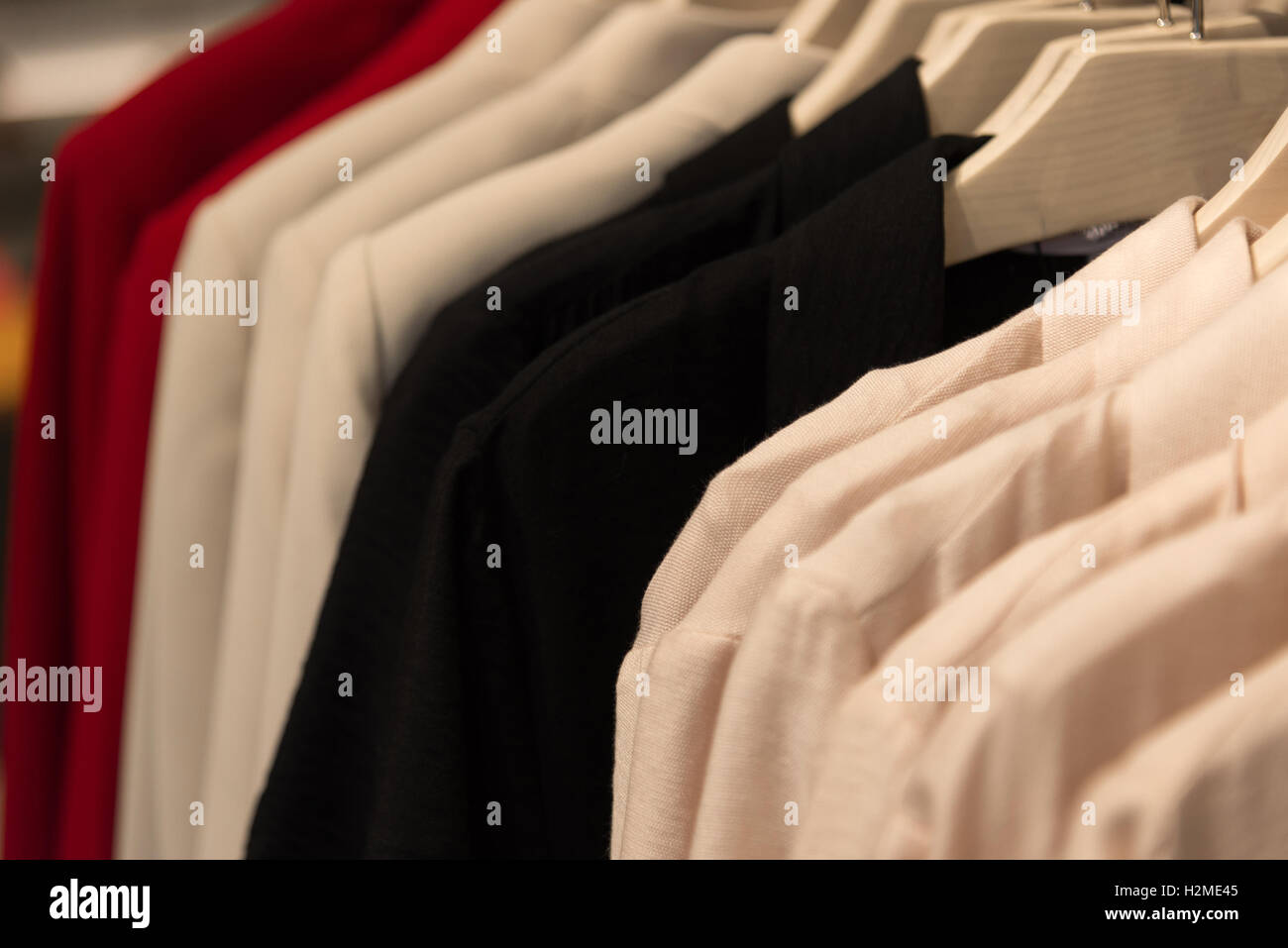 Womens clothes hanging on hangers in store Stock Photo - Alamy