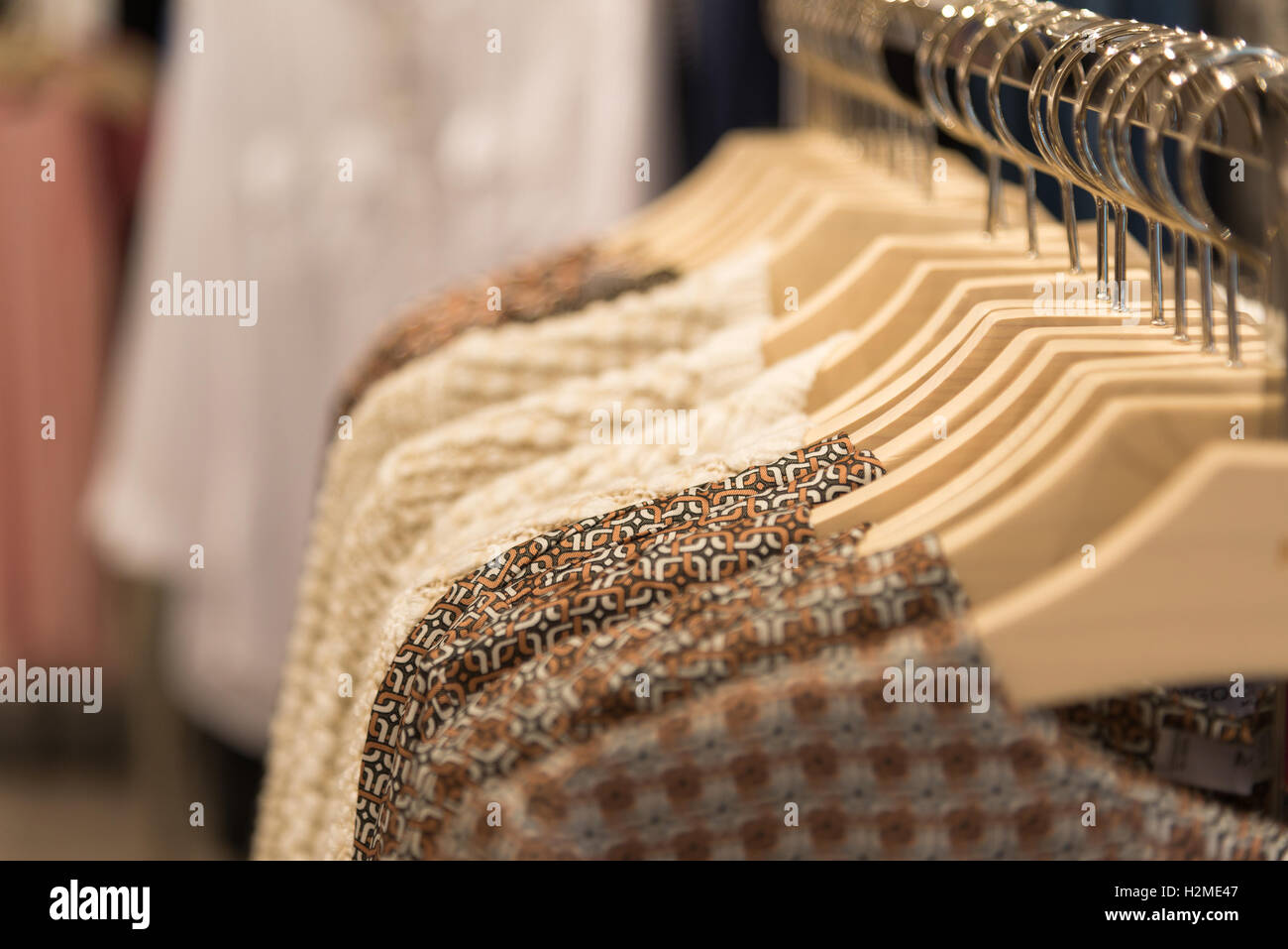 Womens clothes hanging on hangers in store Stock Photo - Alamy