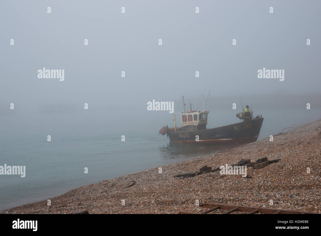 Fishing boat landing in the mist Stock Photo - Alamy