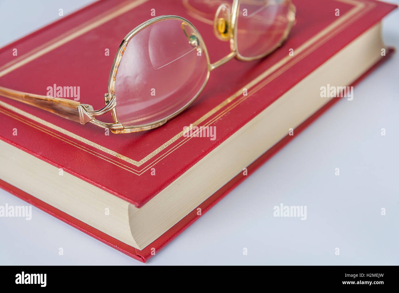 Reading Glasses On The Book Stock Photo - Alamy