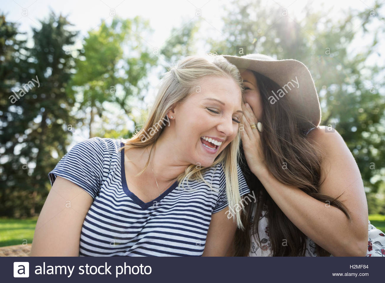 Friends whispering hi-res stock photography and images - Alamy