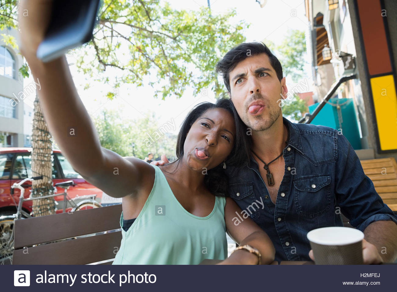 Playful Couple Making Silly Faces And Taking Selfie With Camera Phone