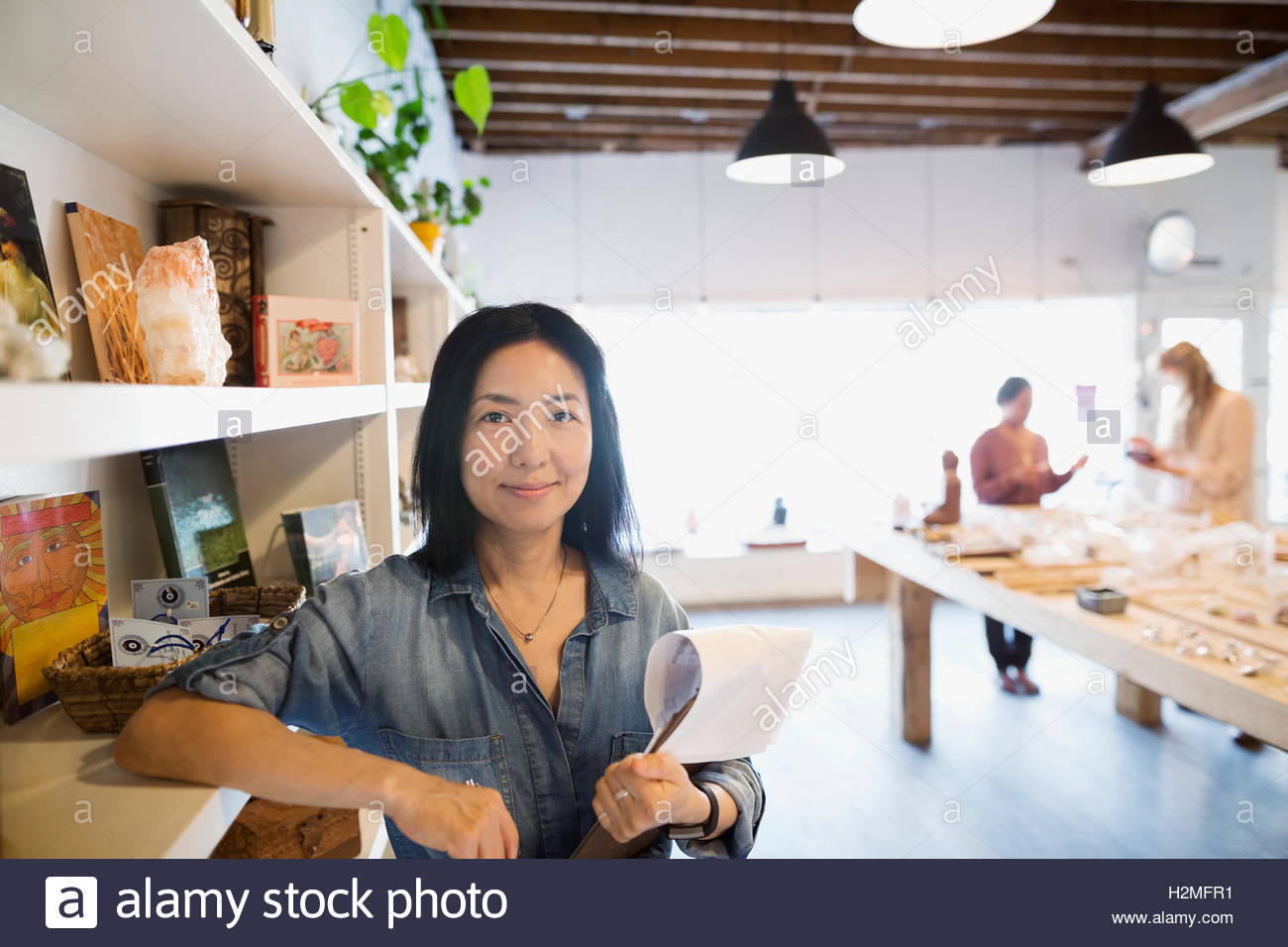 Portrait confident female shop owner with clipboard Stock Photo - Alamy