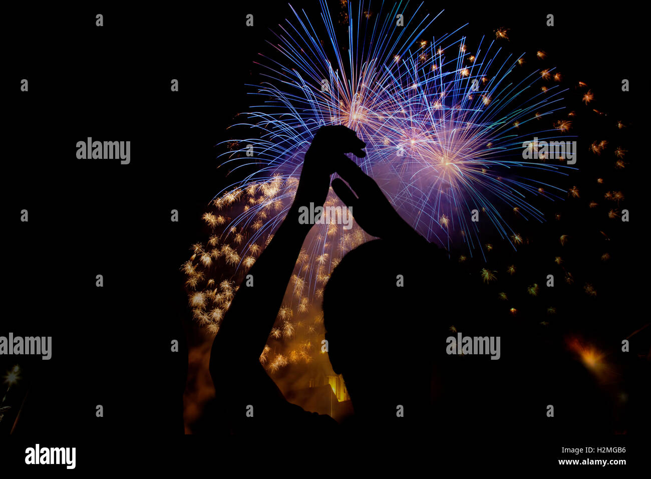 New Year concept - cheering crowd and fireworks Stock Photo - Alamy