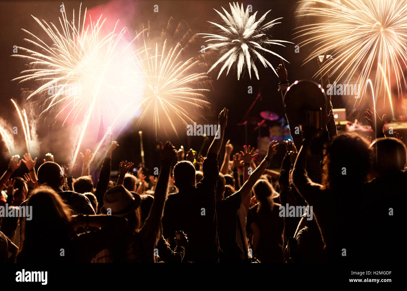 New Year concept - cheering crowd and fireworks Stock Photo - Alamy