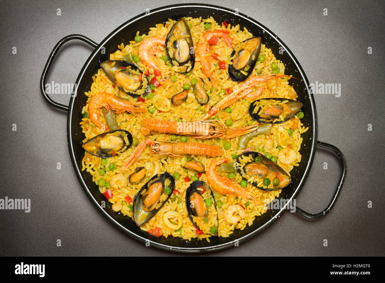 Spanish paella on dark background Stock Photo - Alamy