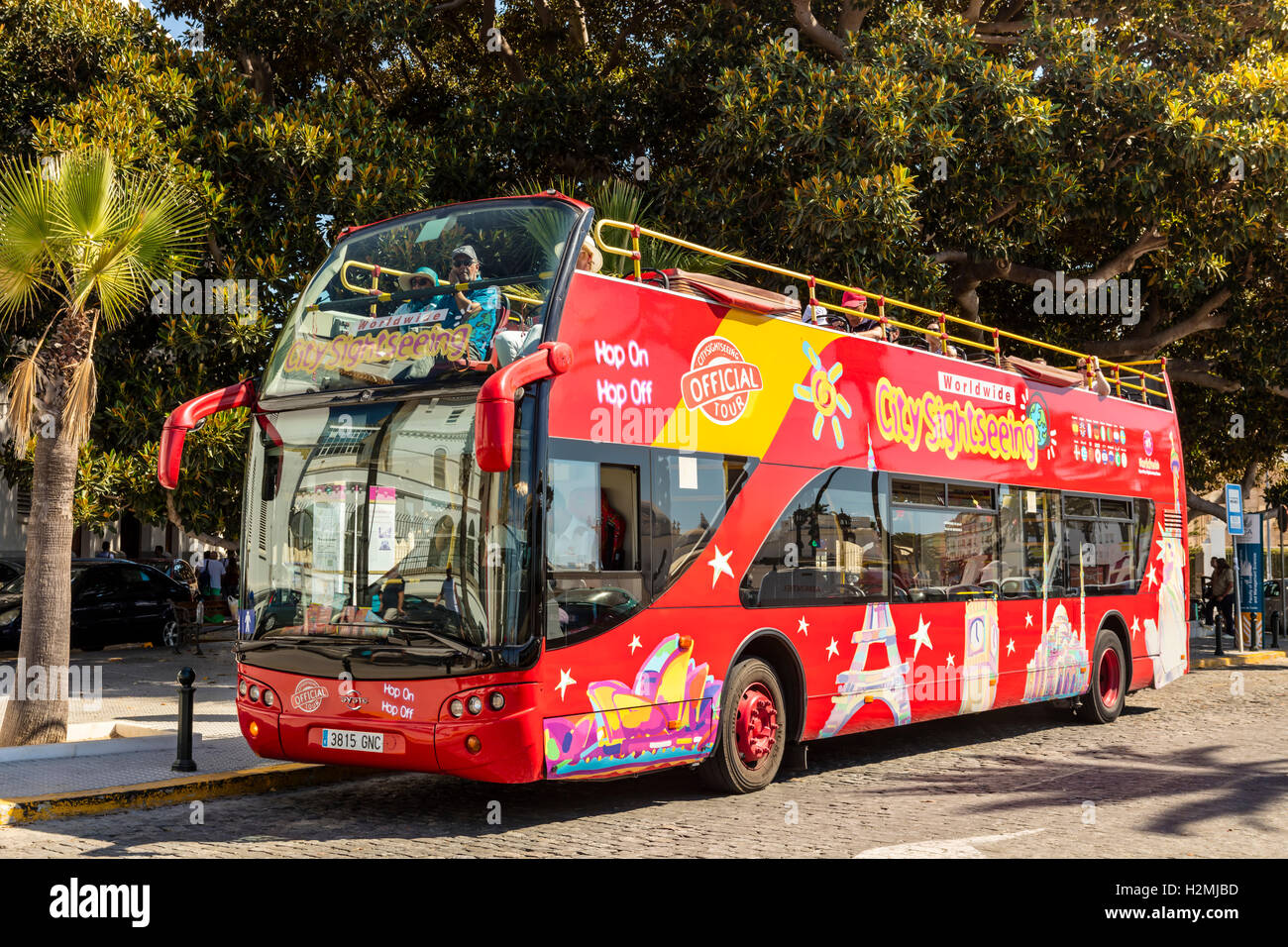 Brightly decorated sightseeing double-decker open top bus in Cadiz ...