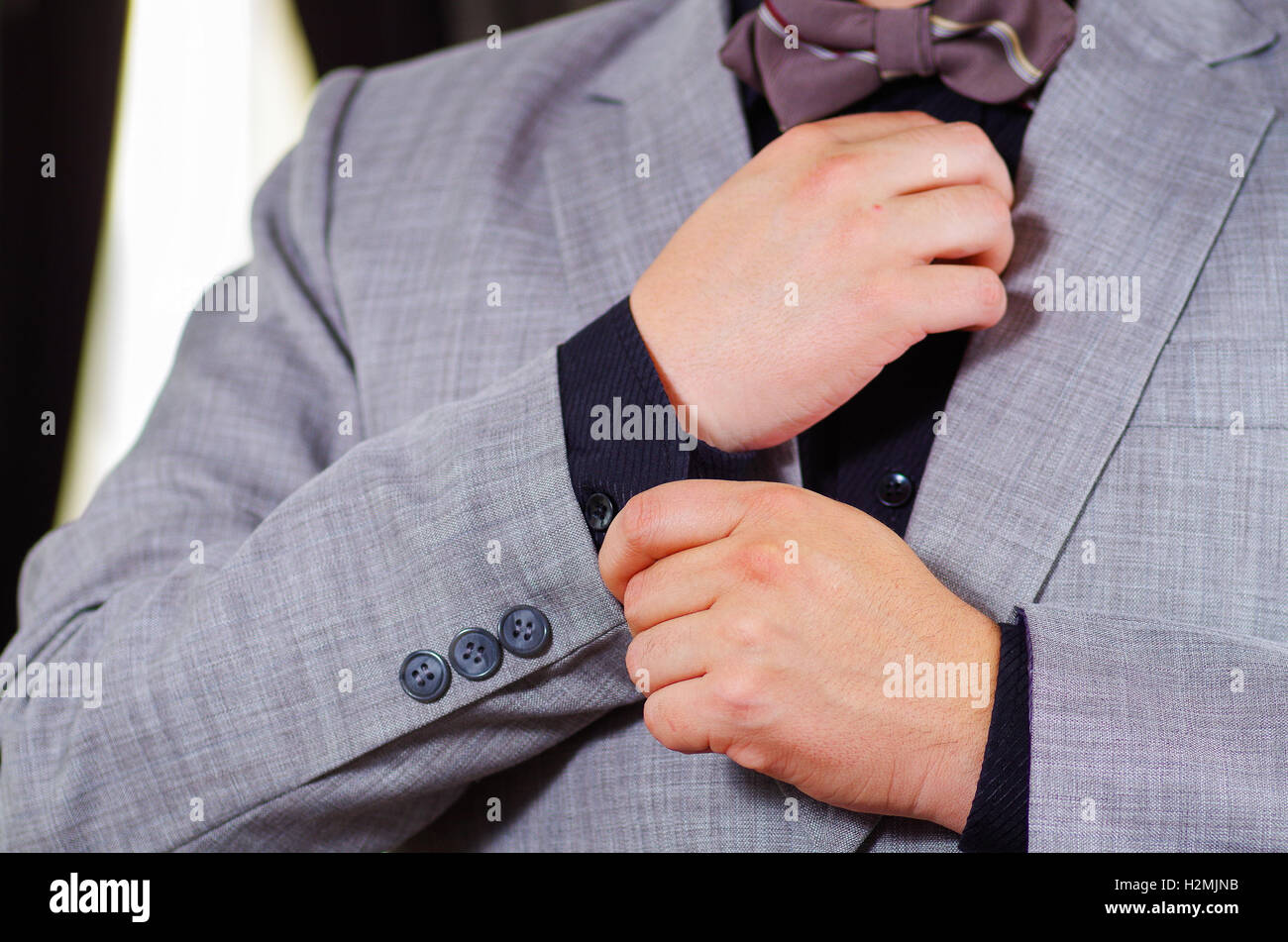 Closeup man's arm wearing suit, adjusting cufflinks using hands, men ...