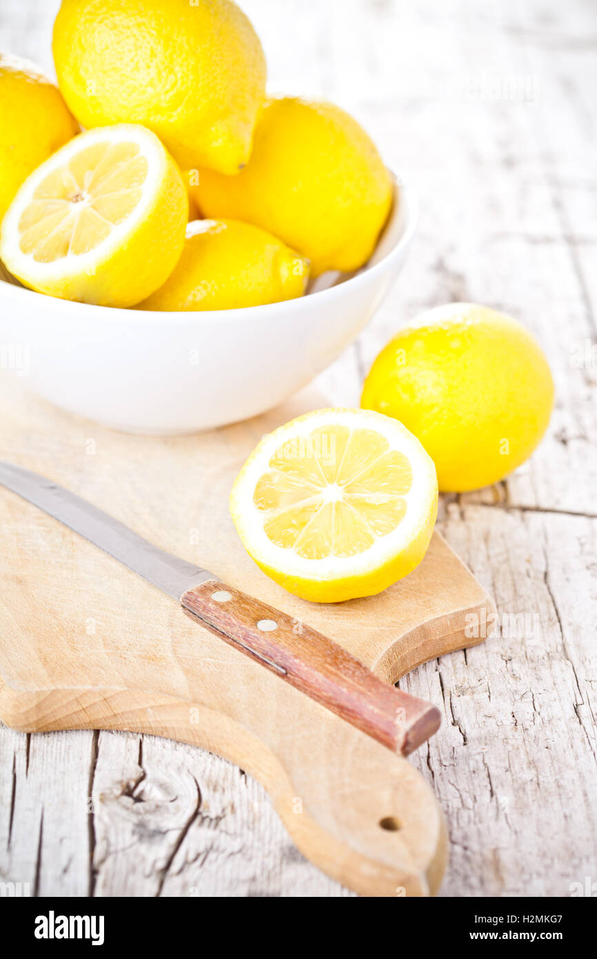 fresh lemons in a bowl and knife Stock Photo - Alamy