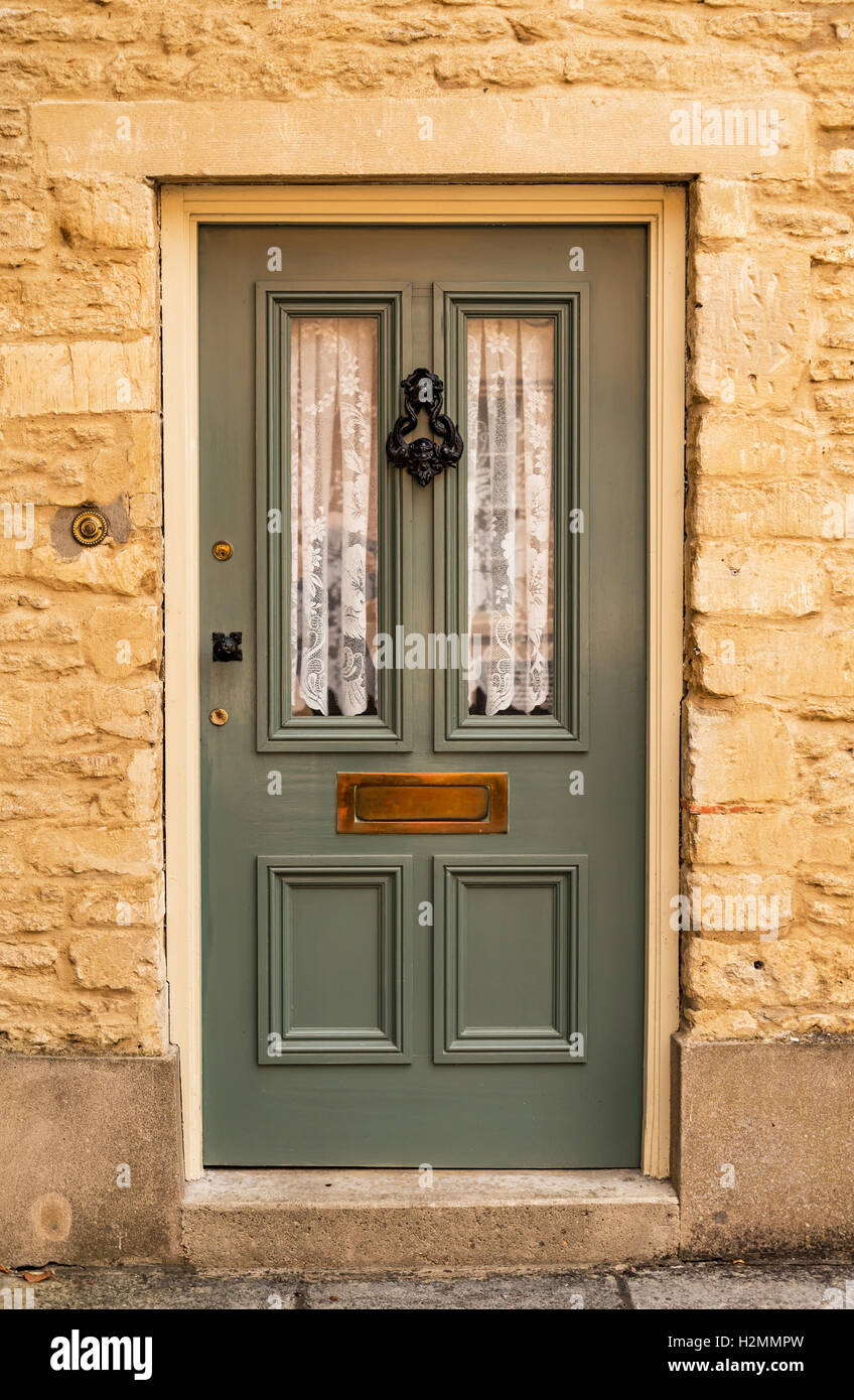 Old english house with brick wall and yellow door hi-res stock ...
