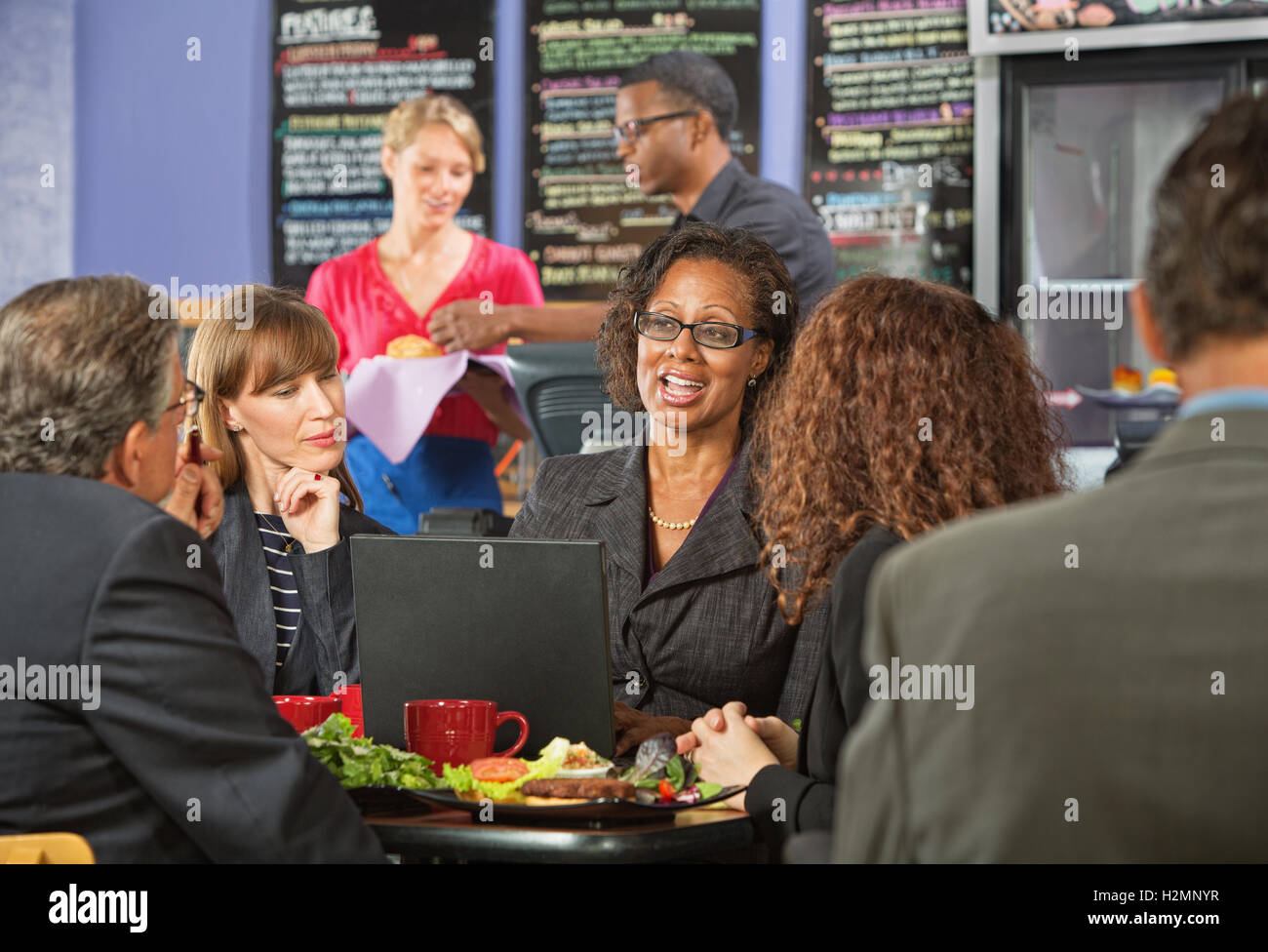 Mature Executives and Working Lunch Stock Photo - Alamy