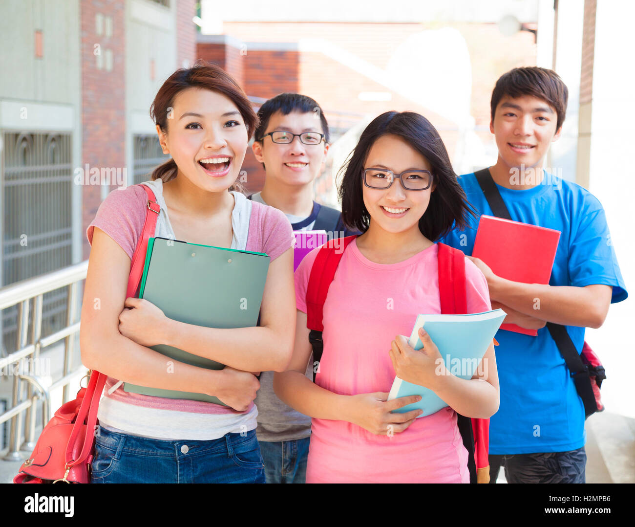 smiling students standing together at campus Stock Photo - Alamy