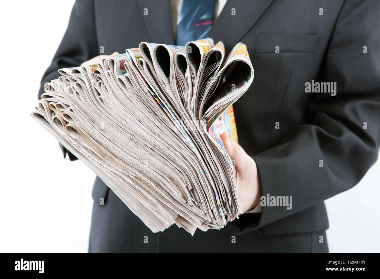 man's hands holding a stack of newspapers Stock Photo - Alamy