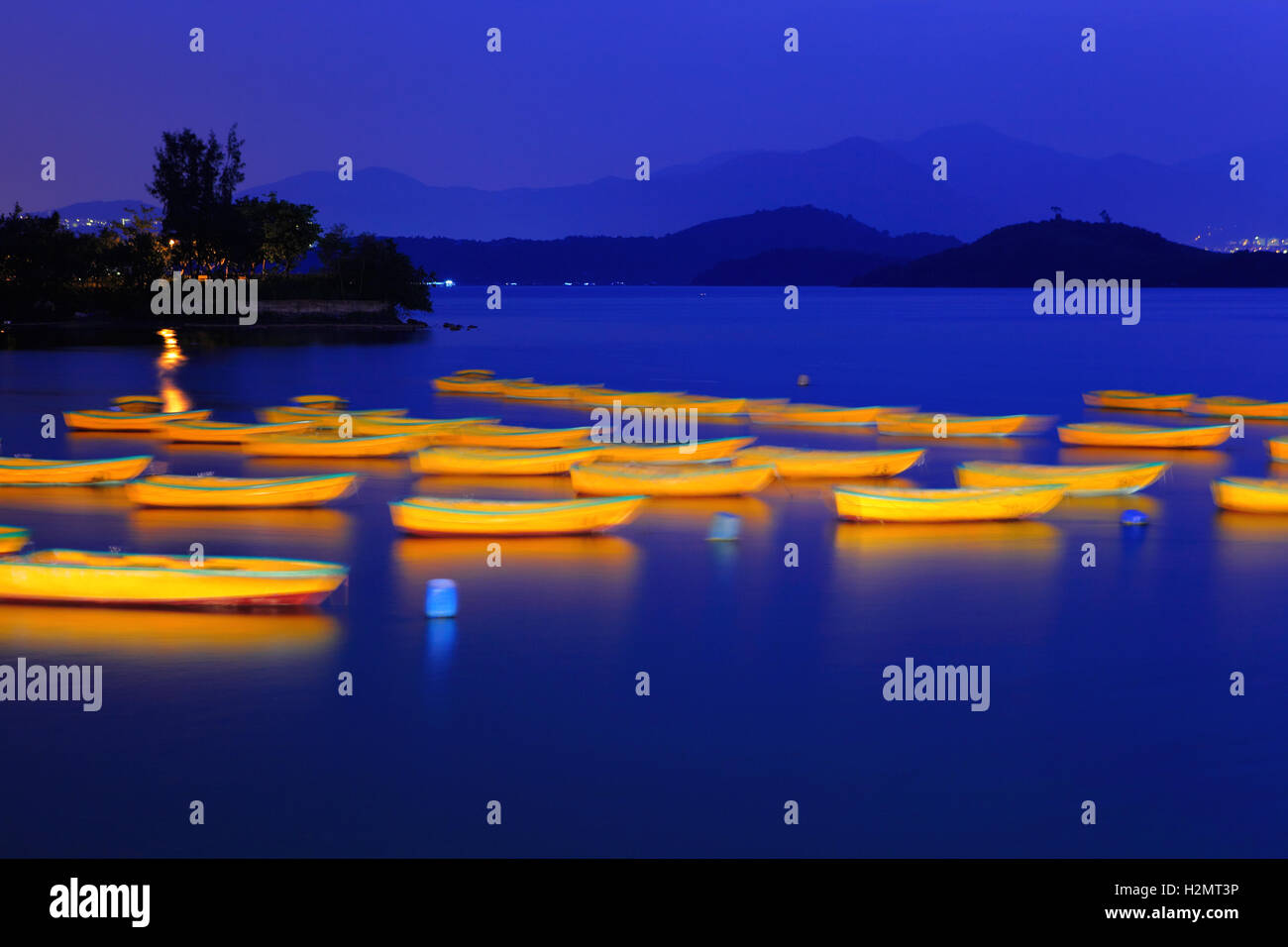 Seascape and small boat at night Stock Photo - Alamy