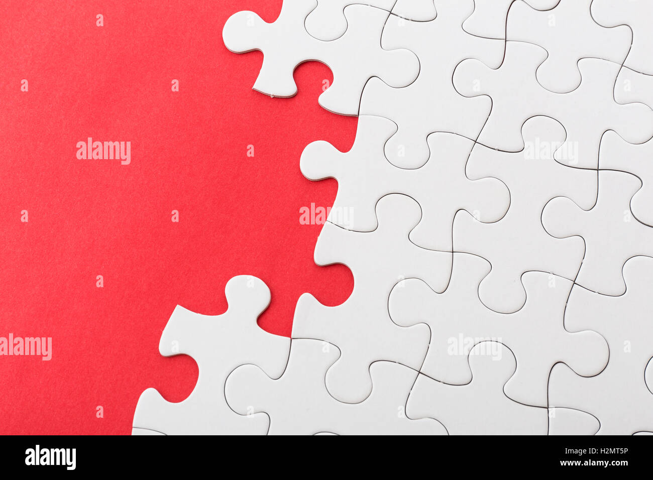 Puzzle missing on red background Stock Photo - Alamy