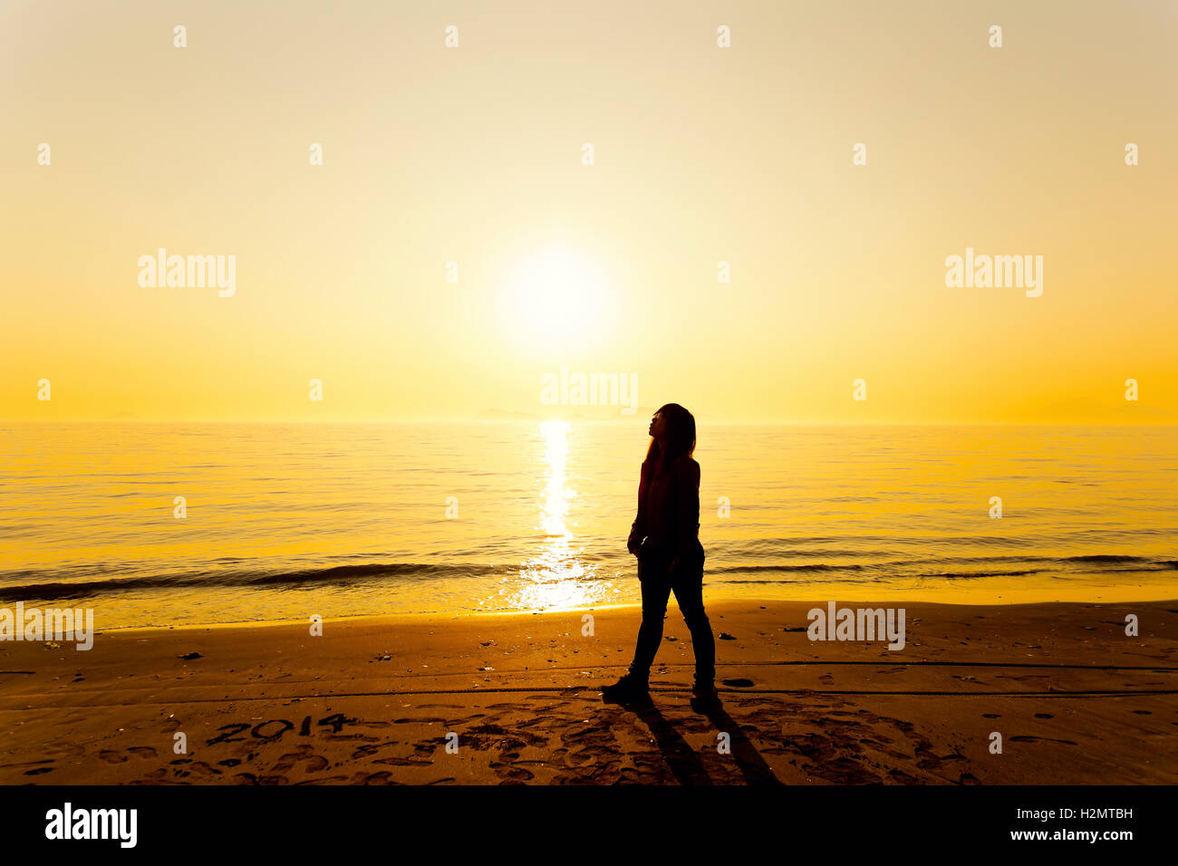 Sunset woman beach standing hi-res stock photography and images - Alamy