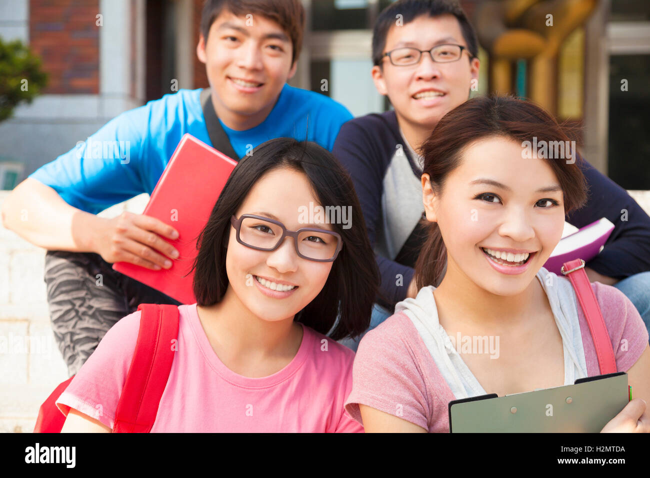 happy university students sitting on stair Stock Photo - Alamy