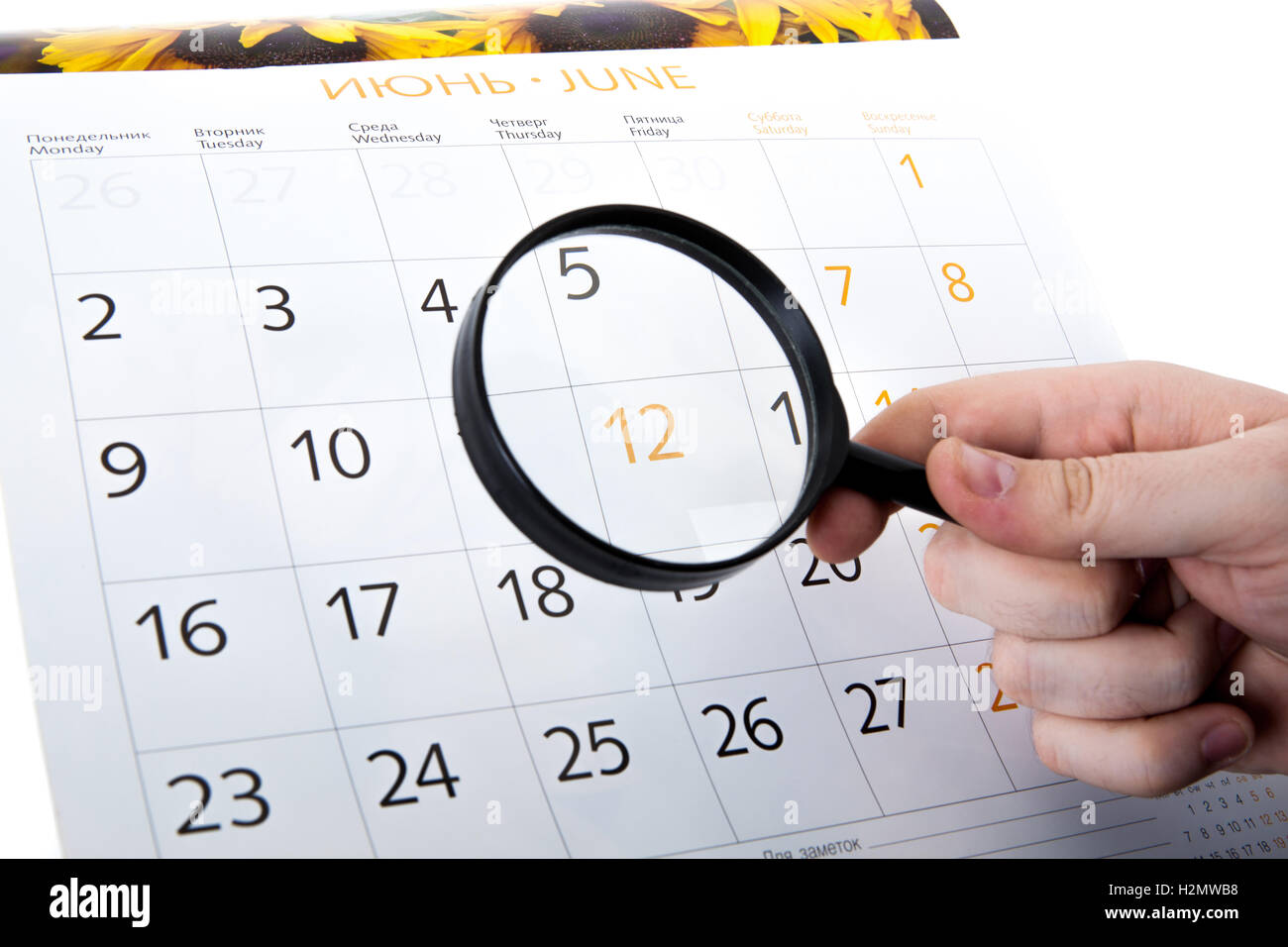 Magnifying glass in hand and the wall calendar Stock Photo - Alamy