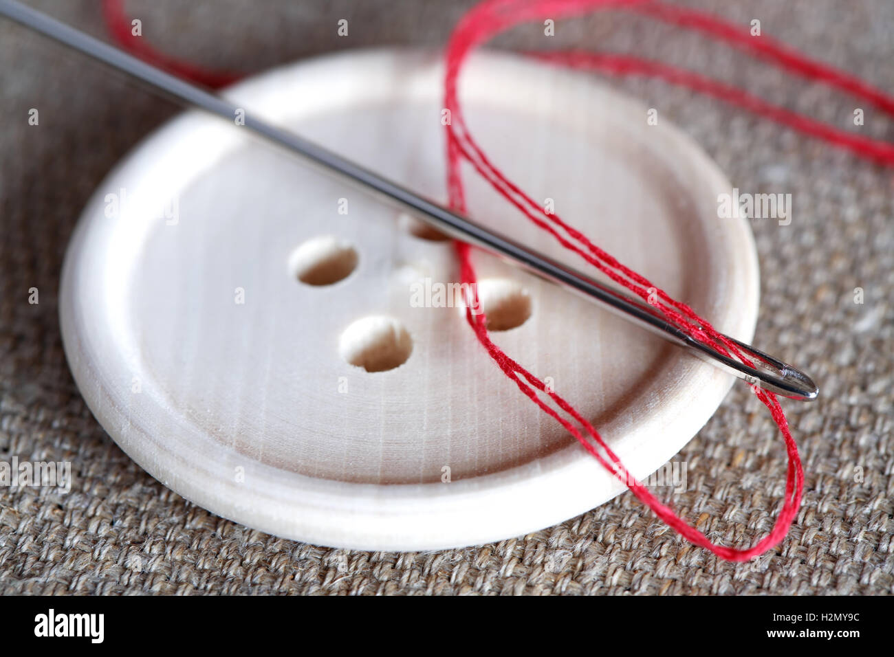 Needle And Button Stock Photo - Alamy