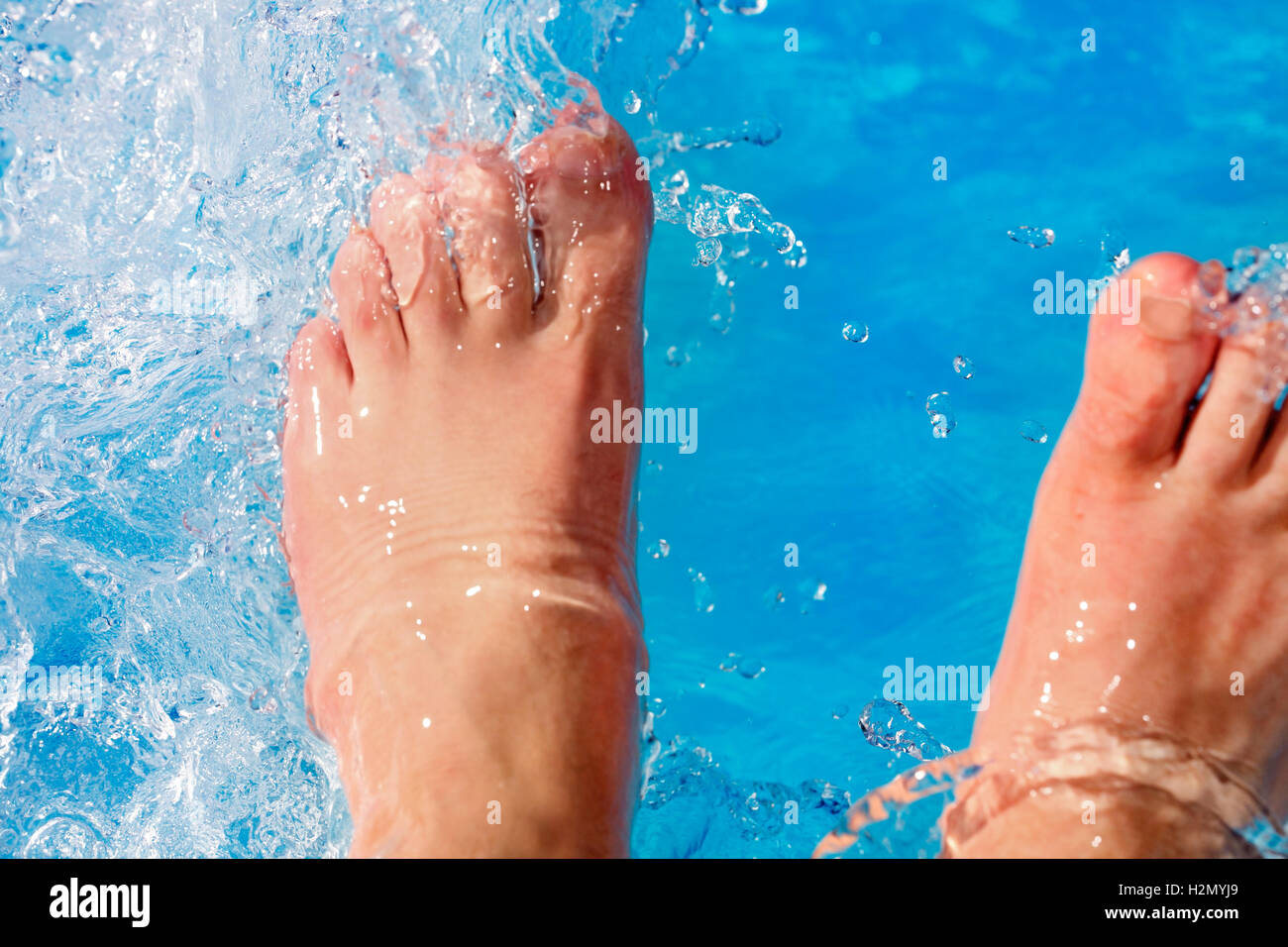 Refreshing the feet in the pool Stock Photo - Alamy