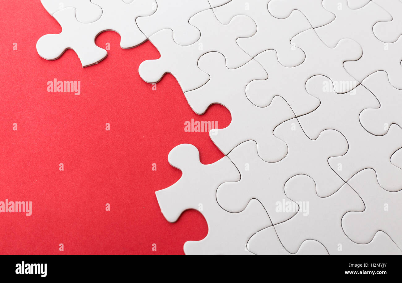 Incomplete puzzle with red missing part Stock Photo - Alamy