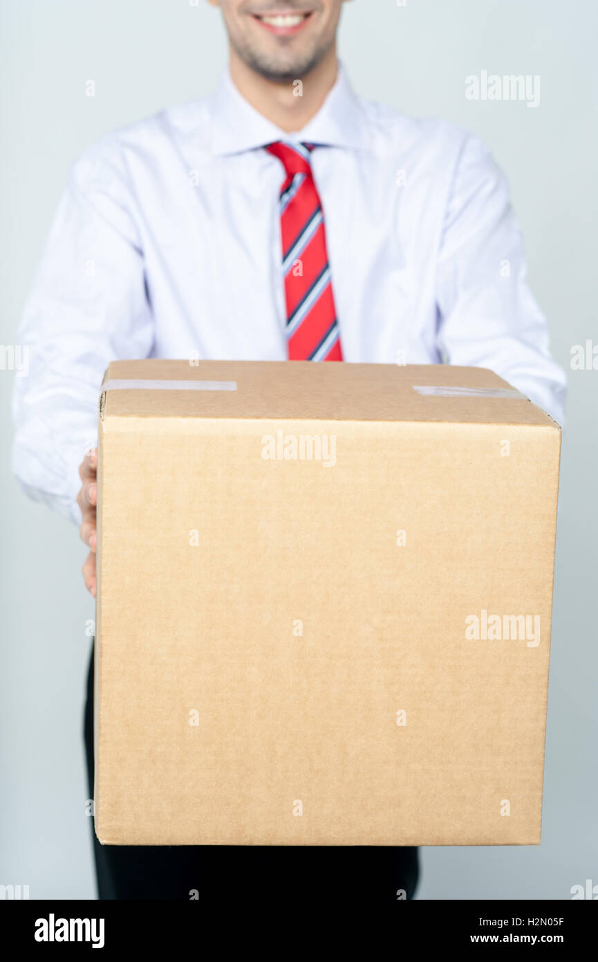 Delivery man with box Stock Photo - Alamy