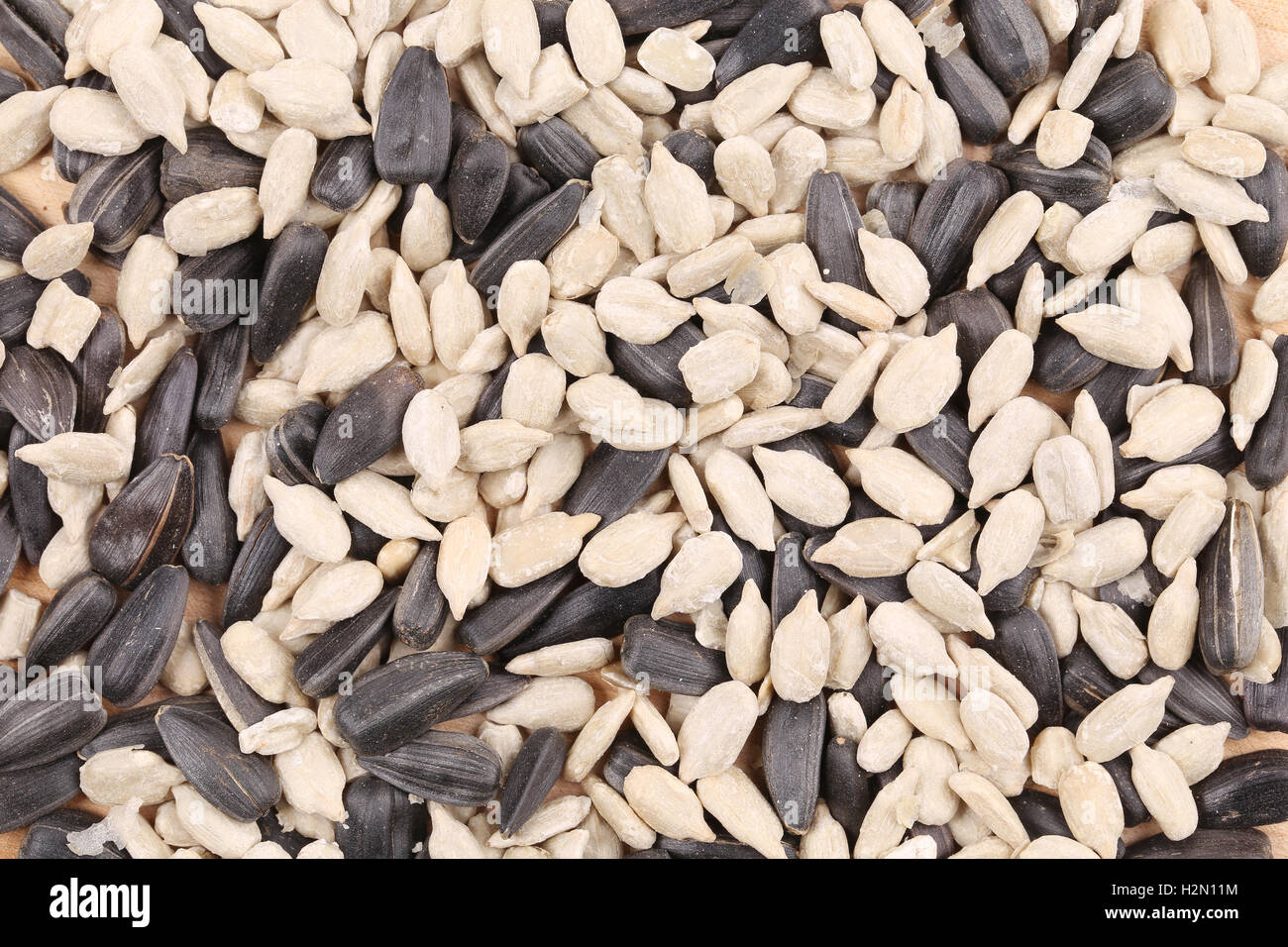 Sunflower seeds in shell and peeled Stock Photo - Alamy