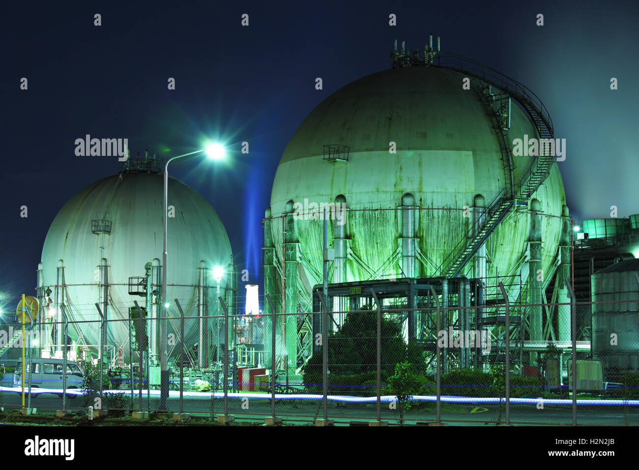 Gas tank at night Stock Photo - Alamy